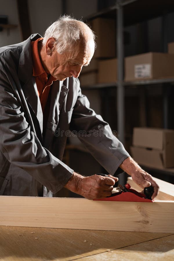Carpenter Using a Hand Plane for Woodworking in His Workshop. Skilled ...