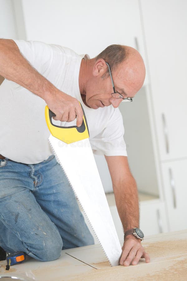 Carpenter using hand saw stock photo. Image of revamping - 83783180