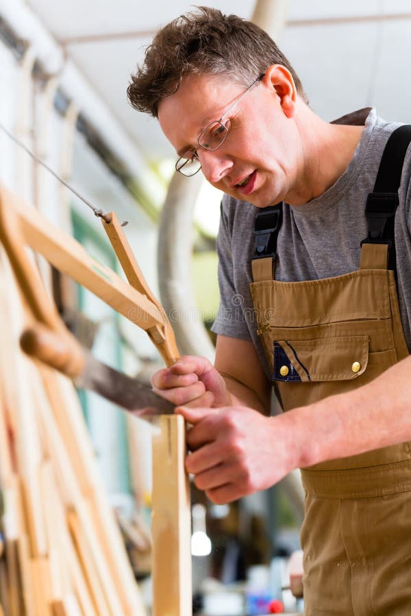 Carpenter using hand saw stock image. Image of carpentry - 36857063