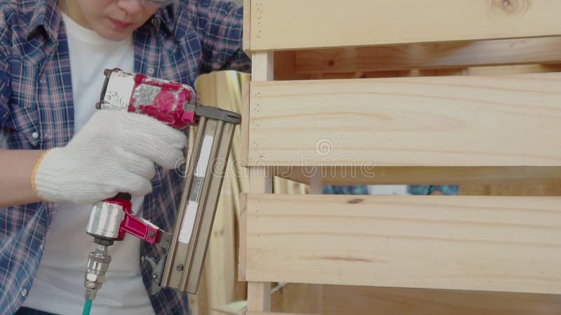 Carpenter Using Nail Gun. Carpenter Using Staple Gun when Working with ...