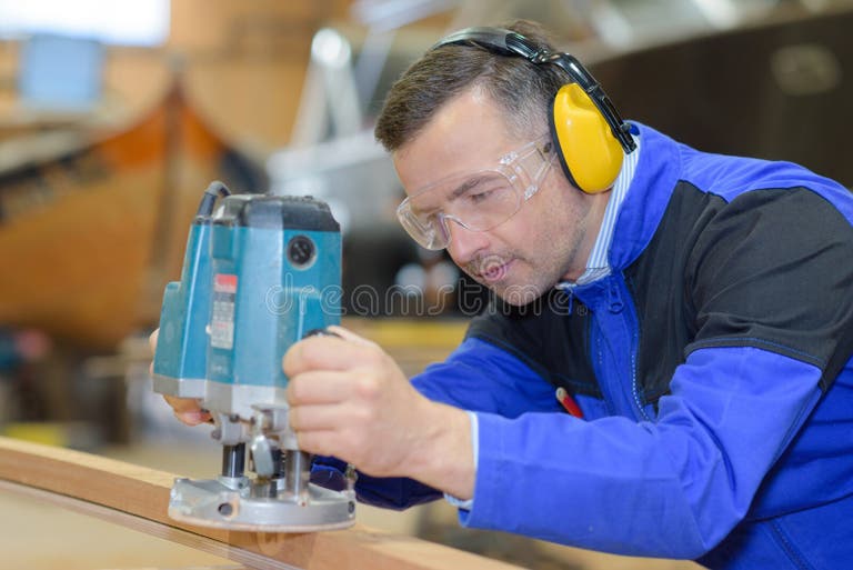 Carpenter using router stock photo. Image of technology - 317247020