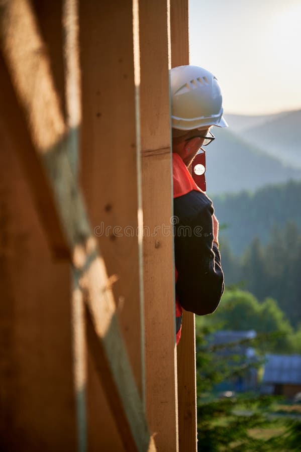 Carpenter Using Spirit Level while Constructing Wooden Frame House ...