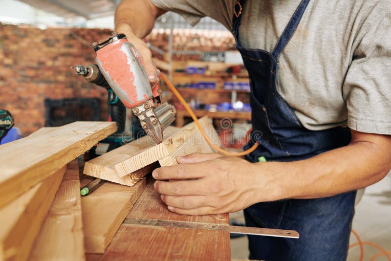 Carpenter using staple gun stock photo. Image of accuracy - 153258818