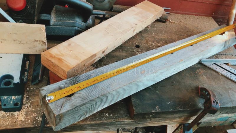 Carpenter Using a Tape Measure Ruler To Measuring Wood Board Stock ...
