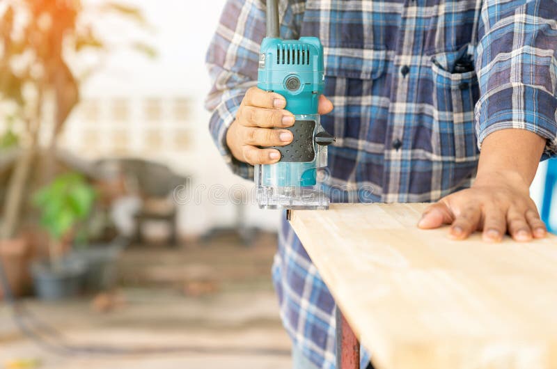 The Carpenter Using a Trimmer To Cut Edging Plank Stock Image - Image ...
