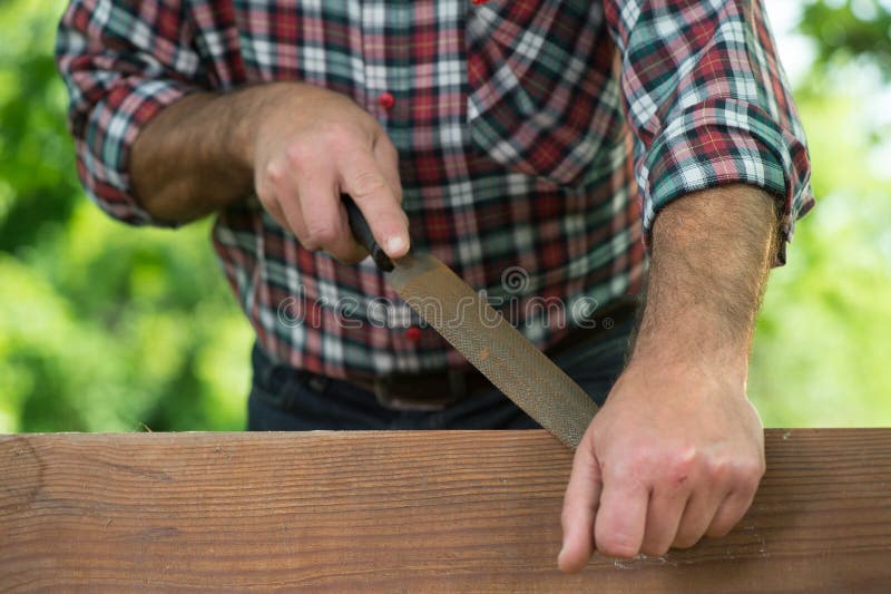Carpenter Using a Wood Rasp on the Edge of a Board Stock Photo - Image ...