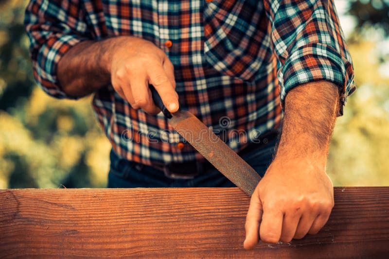 Carpenter Using a Wood Rasp on the Edge of a Board Stock Photo - Image ...