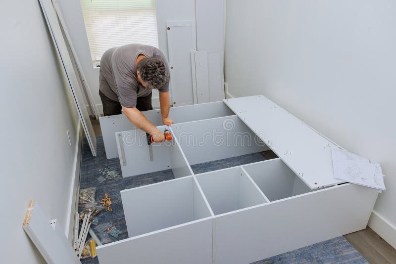A Carpenter Was in the Process of Assembling the Wardrobe Cabinet that ...