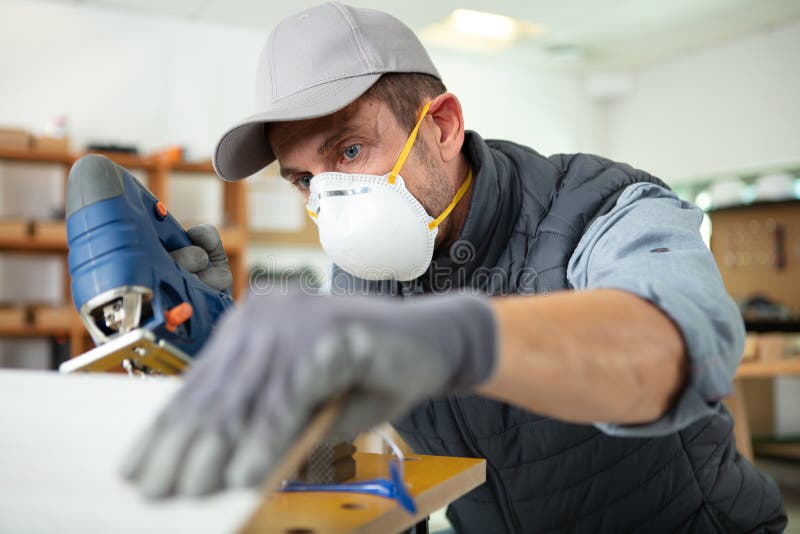 Carpenter Wearing Mask while Using Electric Jigsaw Stock Image - Image ...