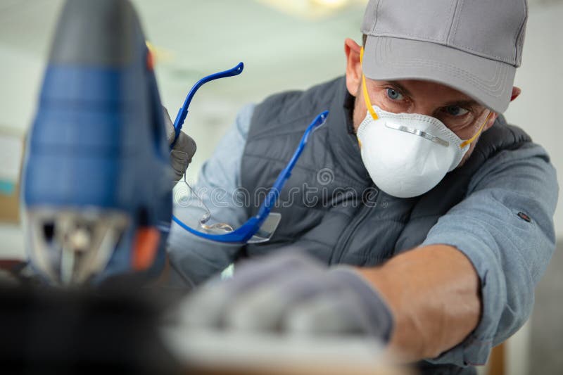 Carpenter Wearing Protective Mask Using Electric Saw Stock Image ...
