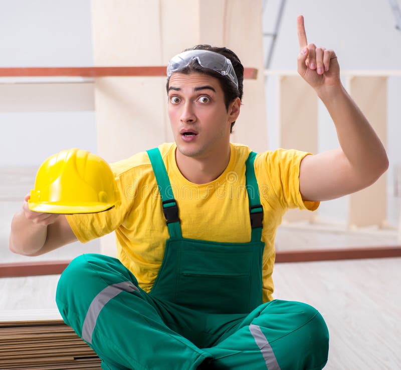 Carpenter Wearing Yellow Hardhat in Contractor Workshop Stock Photo ...