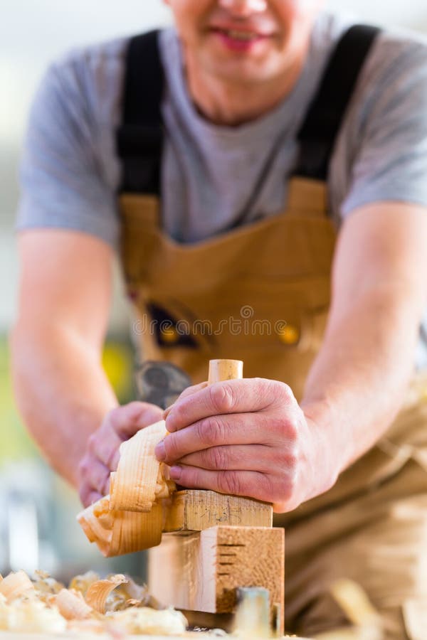 Carpenter with Wood Planer and Workpiece in Carpentry Stock Image ...