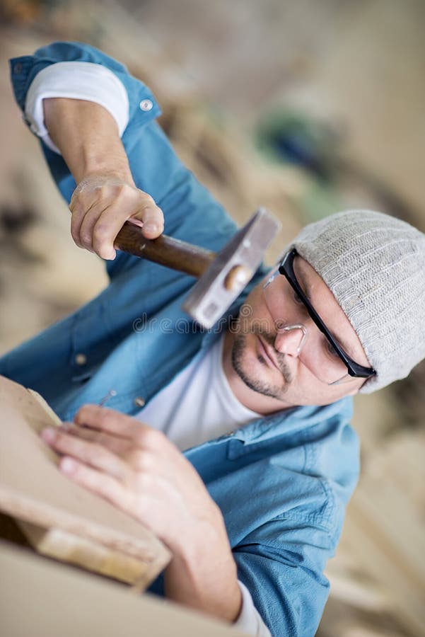 Carpenter at work stock image. Image of males, hammer - 75580921