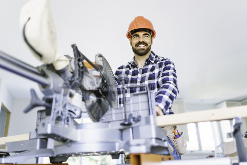 Carpenter at Work on Job Using Power Tool Stock Photo - Image of ...