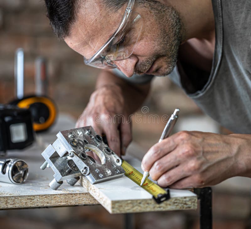 Carpenter at Work, Measuring Wood for Drilling Stock Image - Image of ...