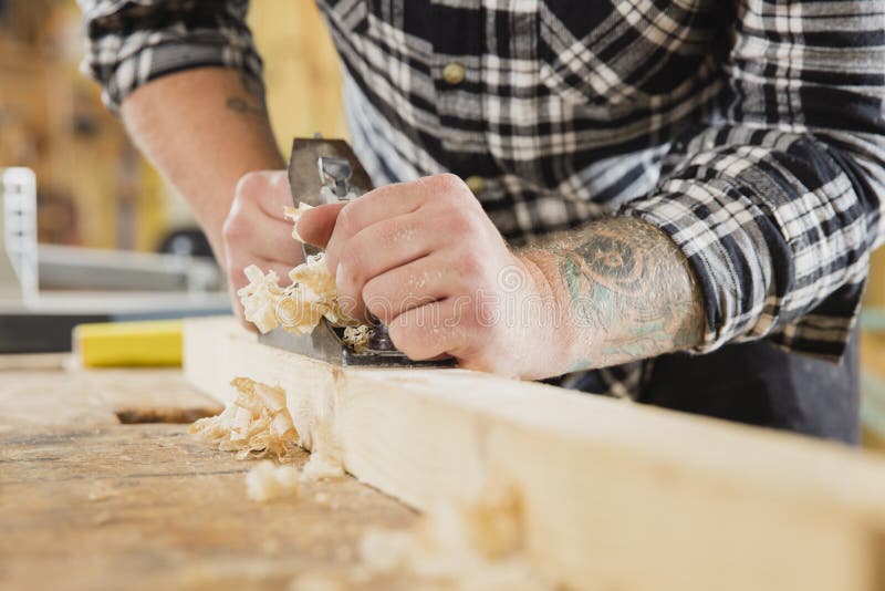 Carpenter Planing a Plank of Wood with a Hand Plane Stock Photo - Image ...