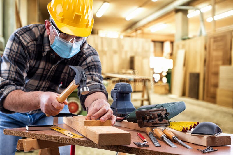 Carpenter at Work Protects the Face with the Surgical Mask. Carpentry ...