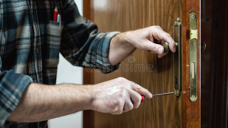 Carpenter at Work Repairs the Door Lock. Carpentry Stock Image - Image ...
