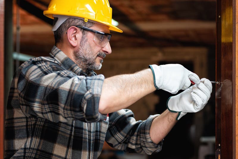 Carpenter at Work Repairs and Installs the Door Frame of a Room Stock ...