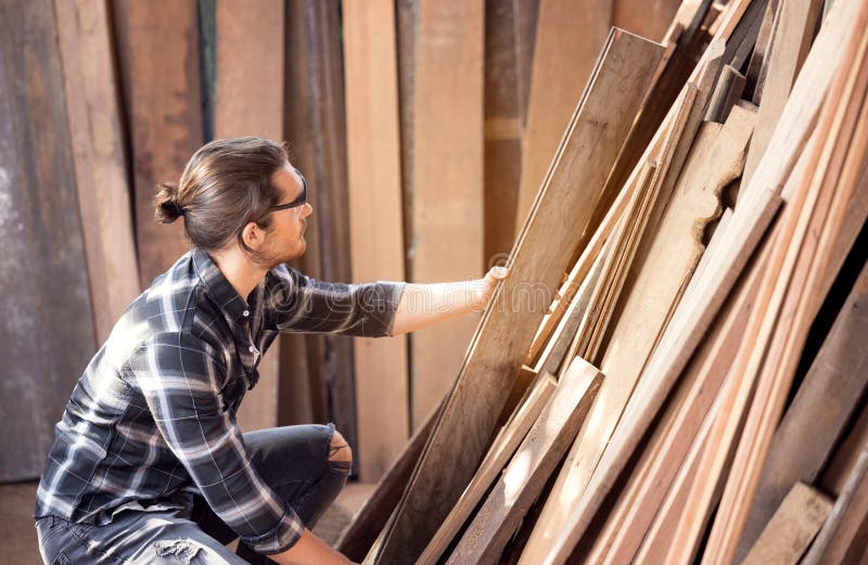 Carpenter Work in Wood Workshop Selecting Timber for His Woddwork Stock ...