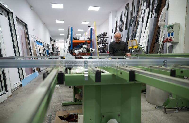 Carpenter Working on Aluminum Window Frame in Workshop Stock Photo ...