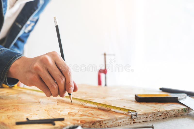 Carpenter Working Carefully Looking at the Plans Work in Carpentry. he ...