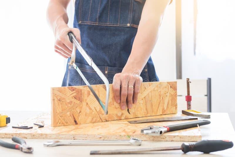Carpenter Working Carefully Looking at the Plans Work in Carpentry. he ...