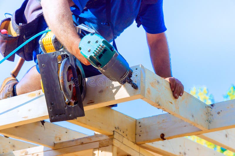 Skilled Worker Using Power Tools To Construct Wooden Framework on a ...