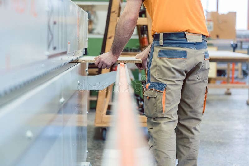 Carpenter Working in Furniture Factory on Machine Stock Image - Image ...