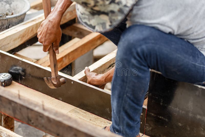 Carpenter Working with Hammer and Meter on Construction Stock Photo ...