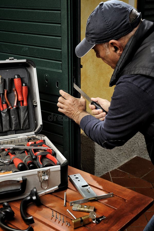 Carpenter Working the Replacement of the Lock of a Door. Stock Image ...
