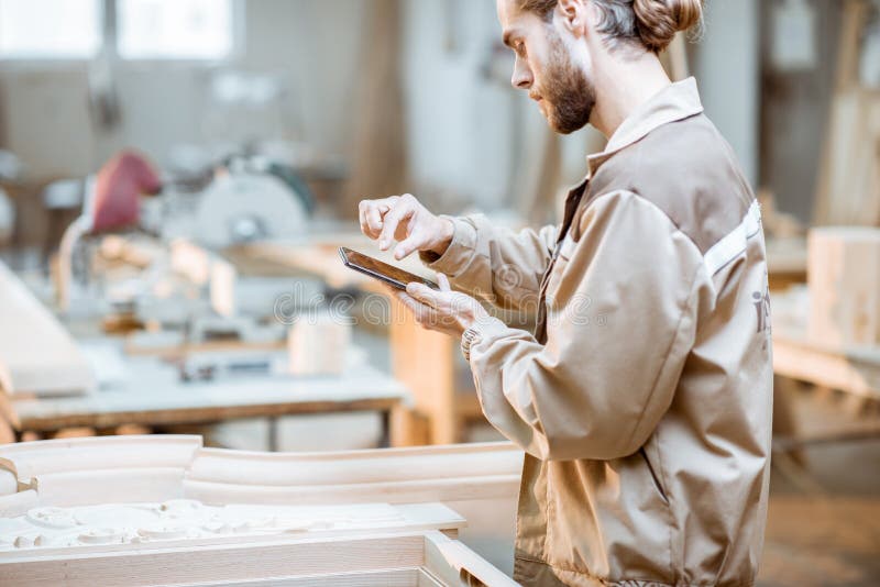 Carpenter Working on Smart Phone at the Carpentry Stock Image - Image ...