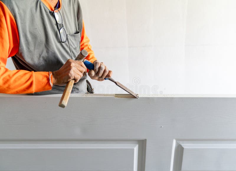 Carpenter Working Using a Chisel with Hole Wooden Door Stock Image ...