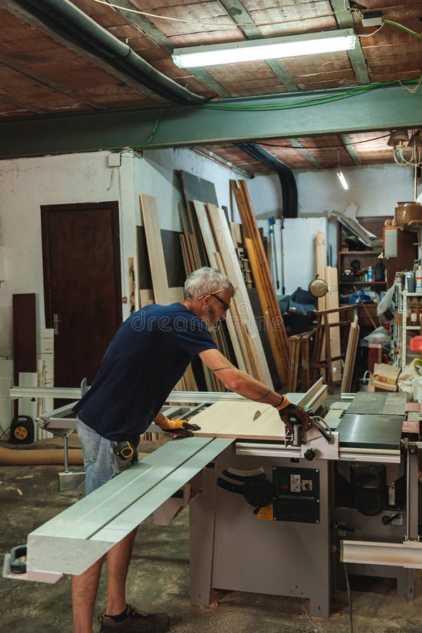 Carpenter Handling Large Pieces of Wood on an Industrial Cutting ...