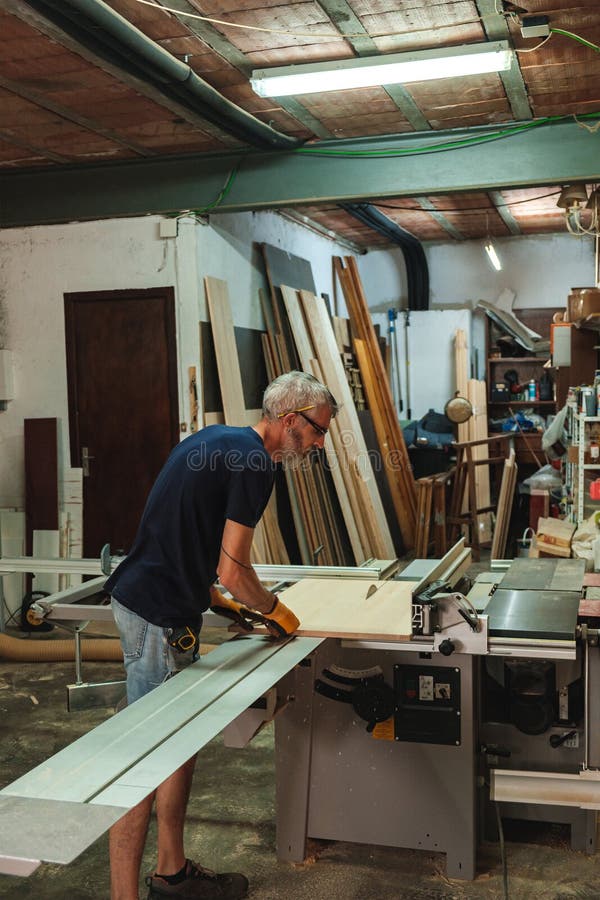 Carpenter Handling Large Pieces of Wood on an Industrial Cutting ...