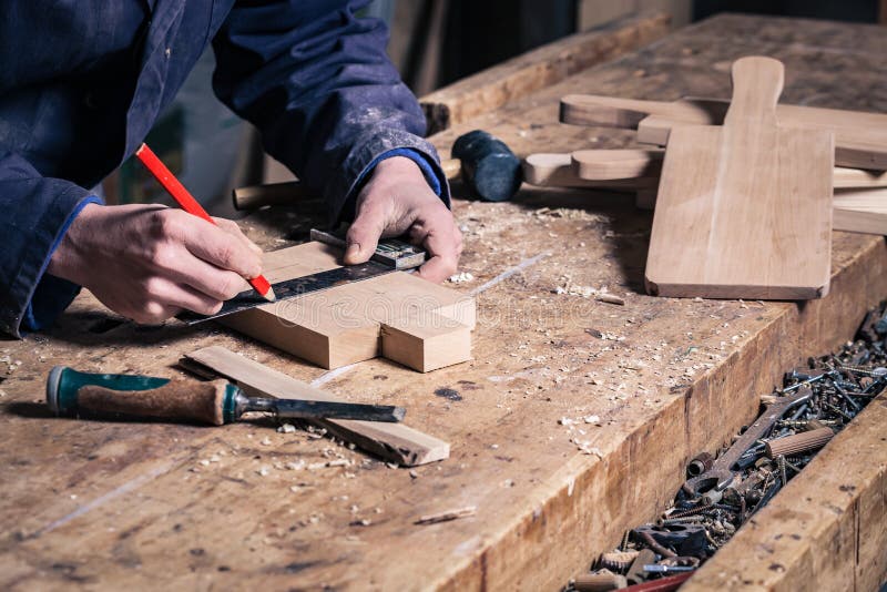 Carpenter Working on a Wooden Cutting Board with Pencil and Rule Stock ...