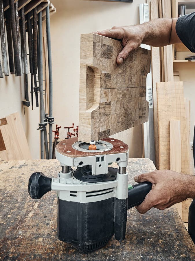 A Carpenter Works with a Hand-held Grinding Machine Stock Image - Image ...