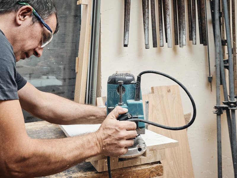 A Carpenter Works with a Hand-held Milling Machine Stock Photo - Image ...