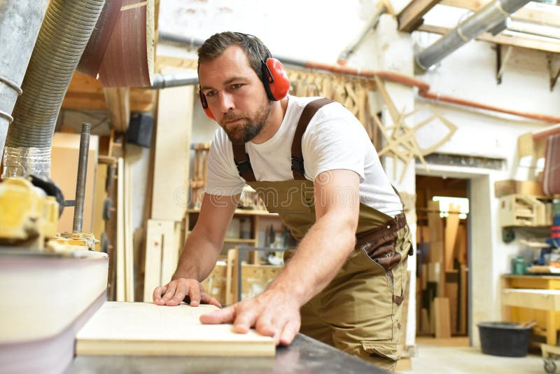 Carpenter Works in a Joinery - Workshop for Woodworking and Sawing ...