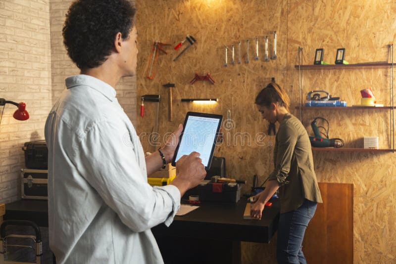 Carpenter in Workshop Holding and Looking at Tablet Stock Photo - Image ...
