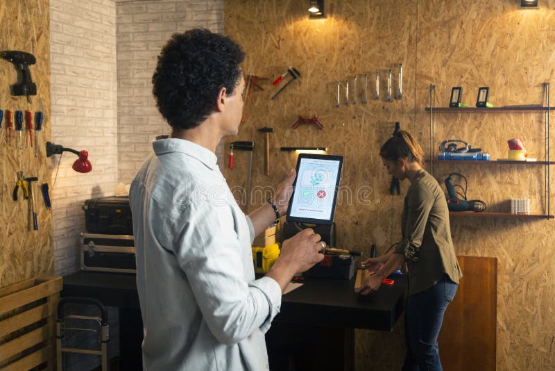 Carpenter in Workshop Holding and Looking at Tablet Stock Image - Image ...