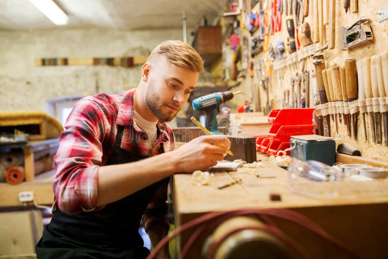 Carpenter Writing To Notebook at Workshop Stock Photo - Image of pencil ...