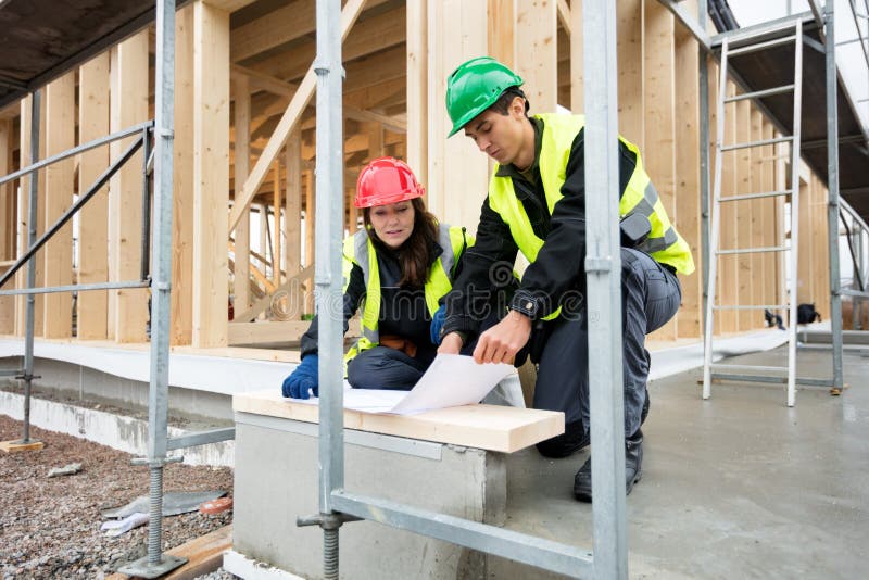 Carpenters Discussing Over Plan at Site Stock Photo - Image of home ...