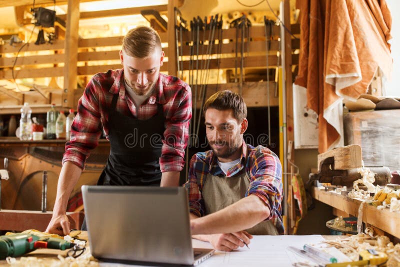 Carpenters with Laptop and Blueprint at Workshop Stock Image - Image of ...