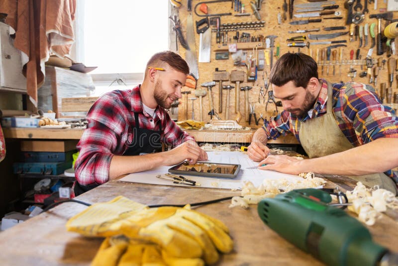 Carpenters with Tablet and Blueprint at Workshop Stock Photo - Image of ...