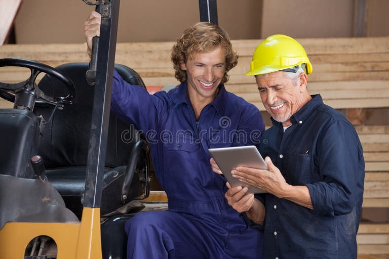Carpenters Using Digital Tablet in Workshop Stock Image - Image of ...