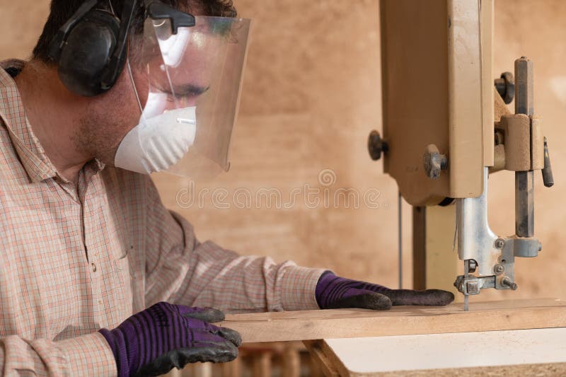 Carpentry Worker Using Band Saw in a Woodworking Workshop Stock Image ...