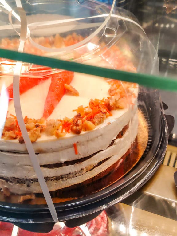 Carrot Cake with Icing Packaged in a Bakery Display Case, Vertical ...