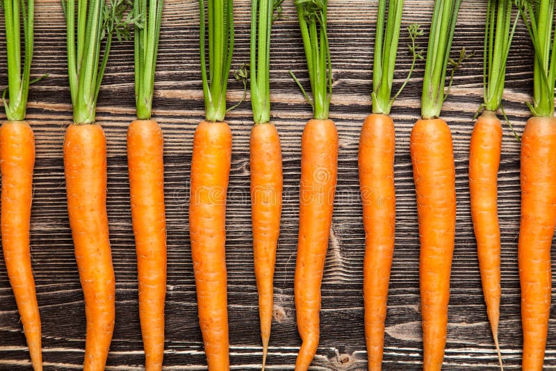 Carrot on wooden table stock image. Image of cutout - 103316869