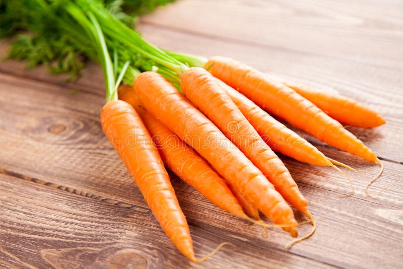 Carrot on a wooden table stock photo. Image of garden - 37753274